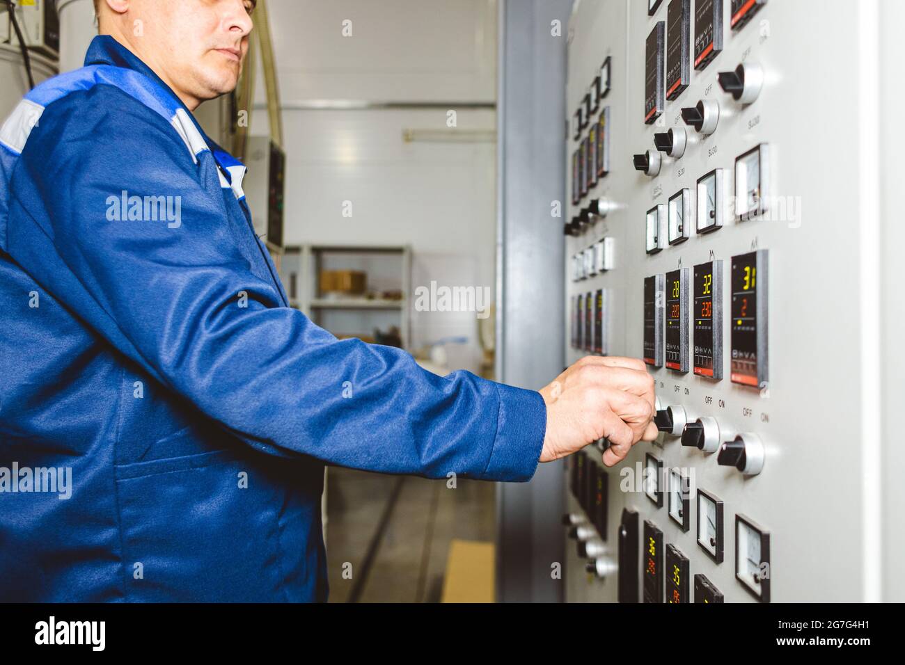 A worker presses a button and starts an automatic manufacturing process ...
