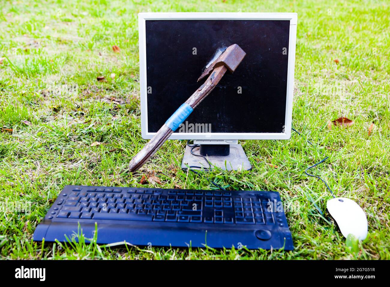 Axe to Smash a Computer Screen on the Grass Background with a Keyboard ...