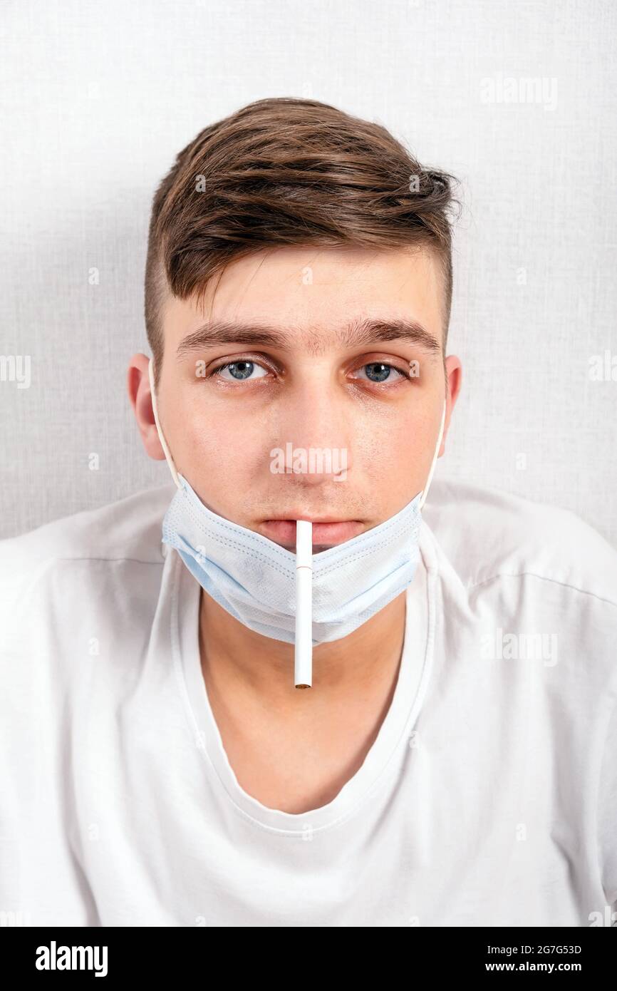 Man with face mask smoking cigarette hi-res stock photography and ...