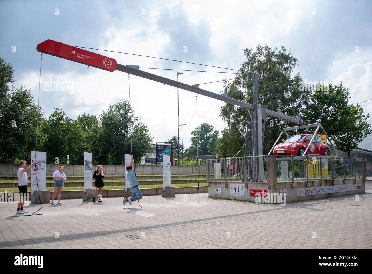 Bremen, Germany. 10th July, 2021. Visitors lift a car weighing 1,500 ...