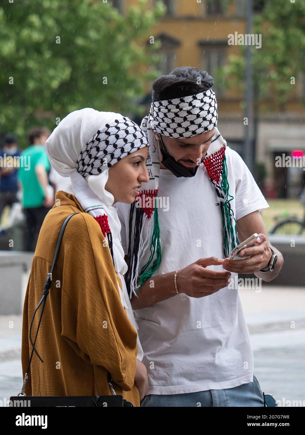 Arab-looking Boy and Girl who are Using a Smartphone to take a Picture ...