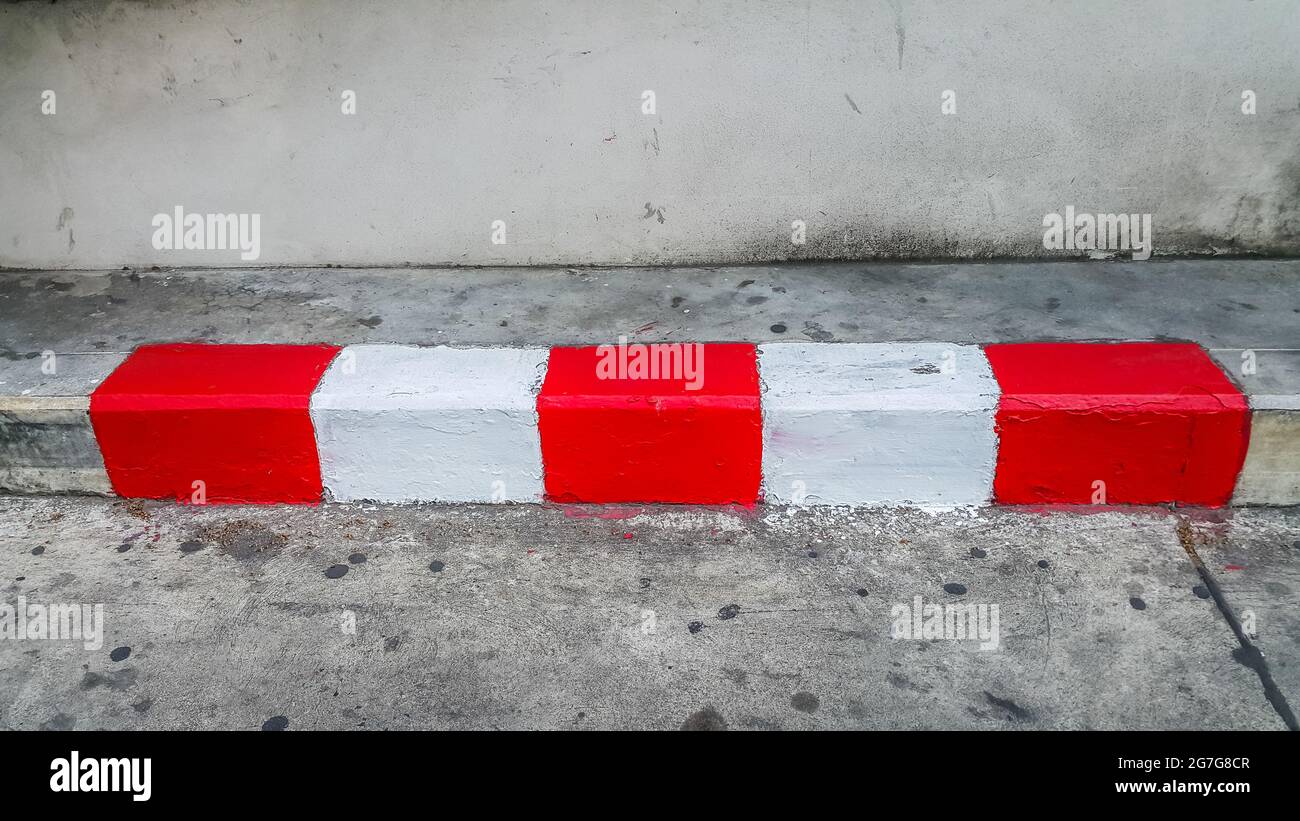 Red and White sign on the sidewalk background Stock Photo - Alamy