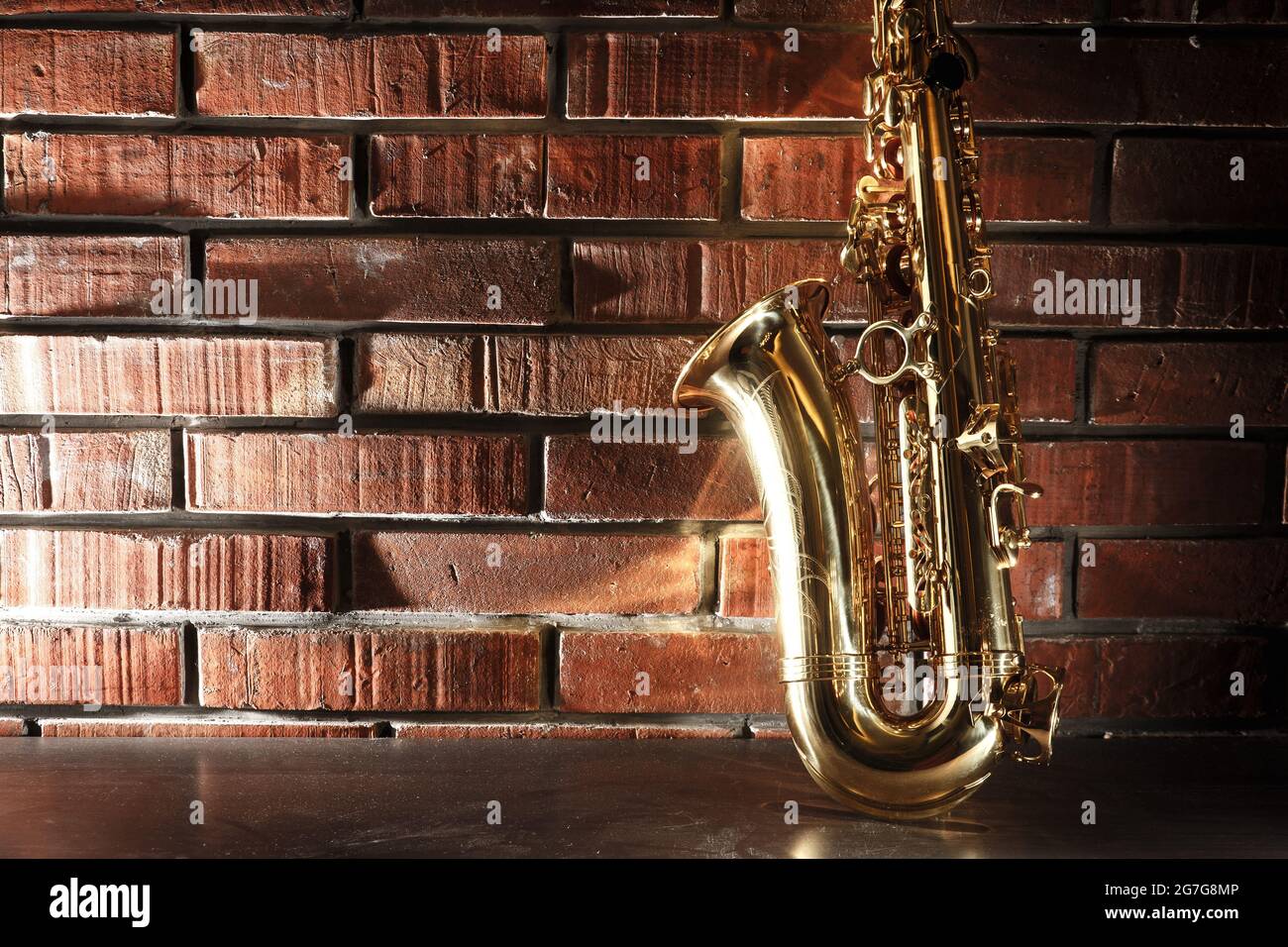 Detail of brass saxophone on brick background Stock Photo - Alamy