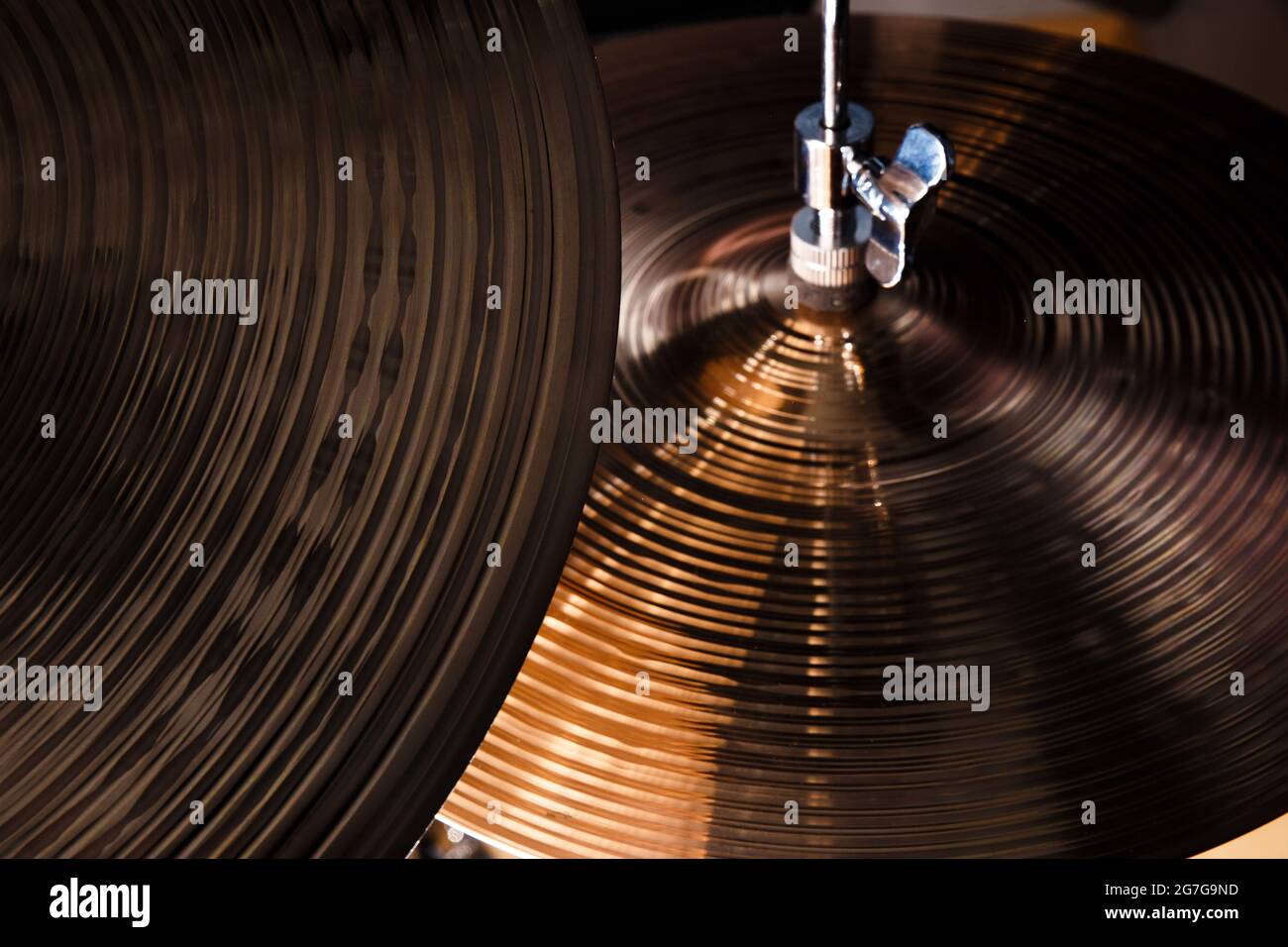 detail of elegant gold cymbal on black background and dramatic lighting ...