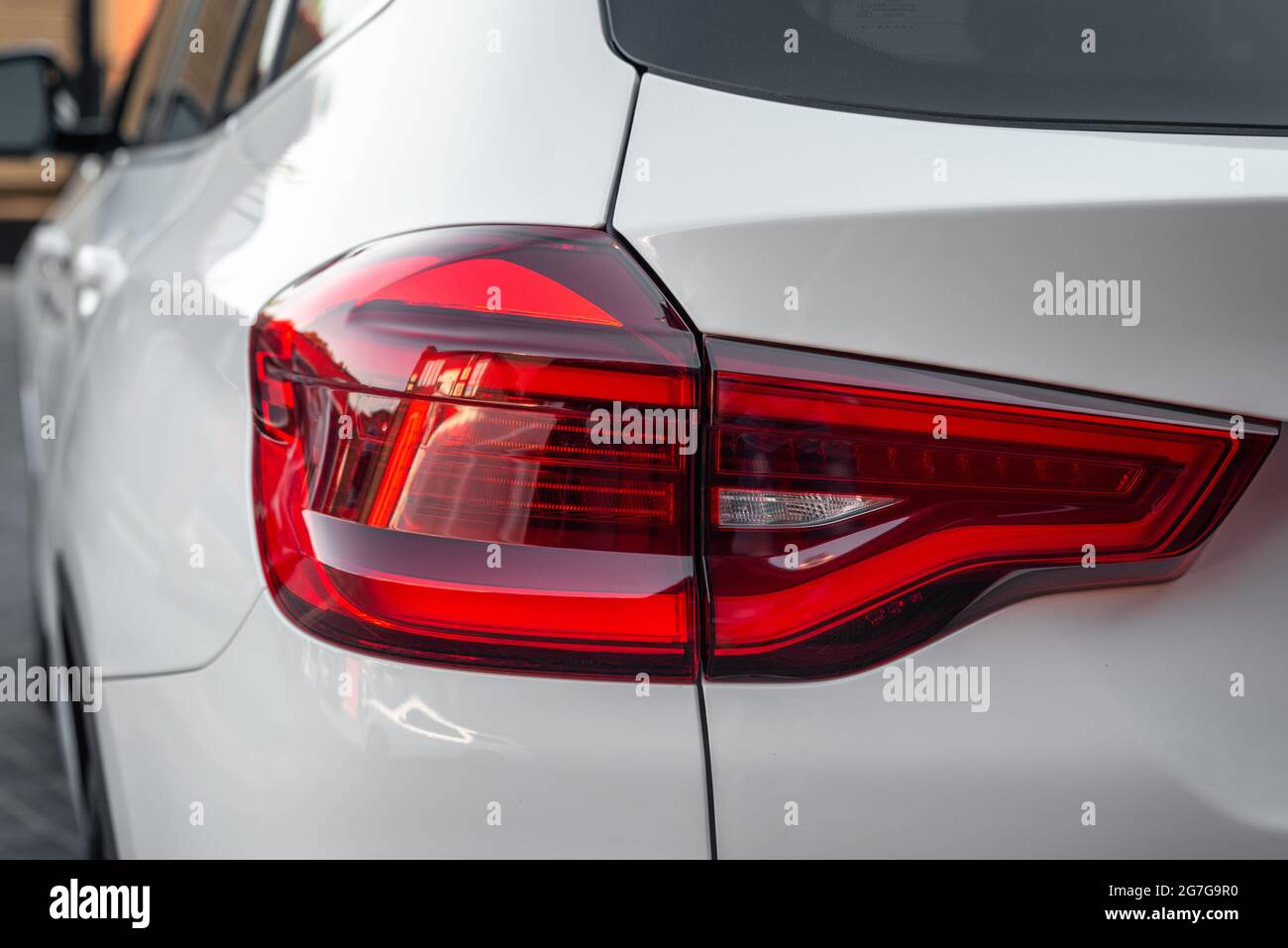 The red headlight of a new modern white color car. Rear stop light of ...