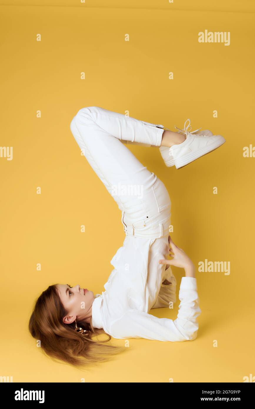 woman standing on her back with her legs raised upside down gold ...