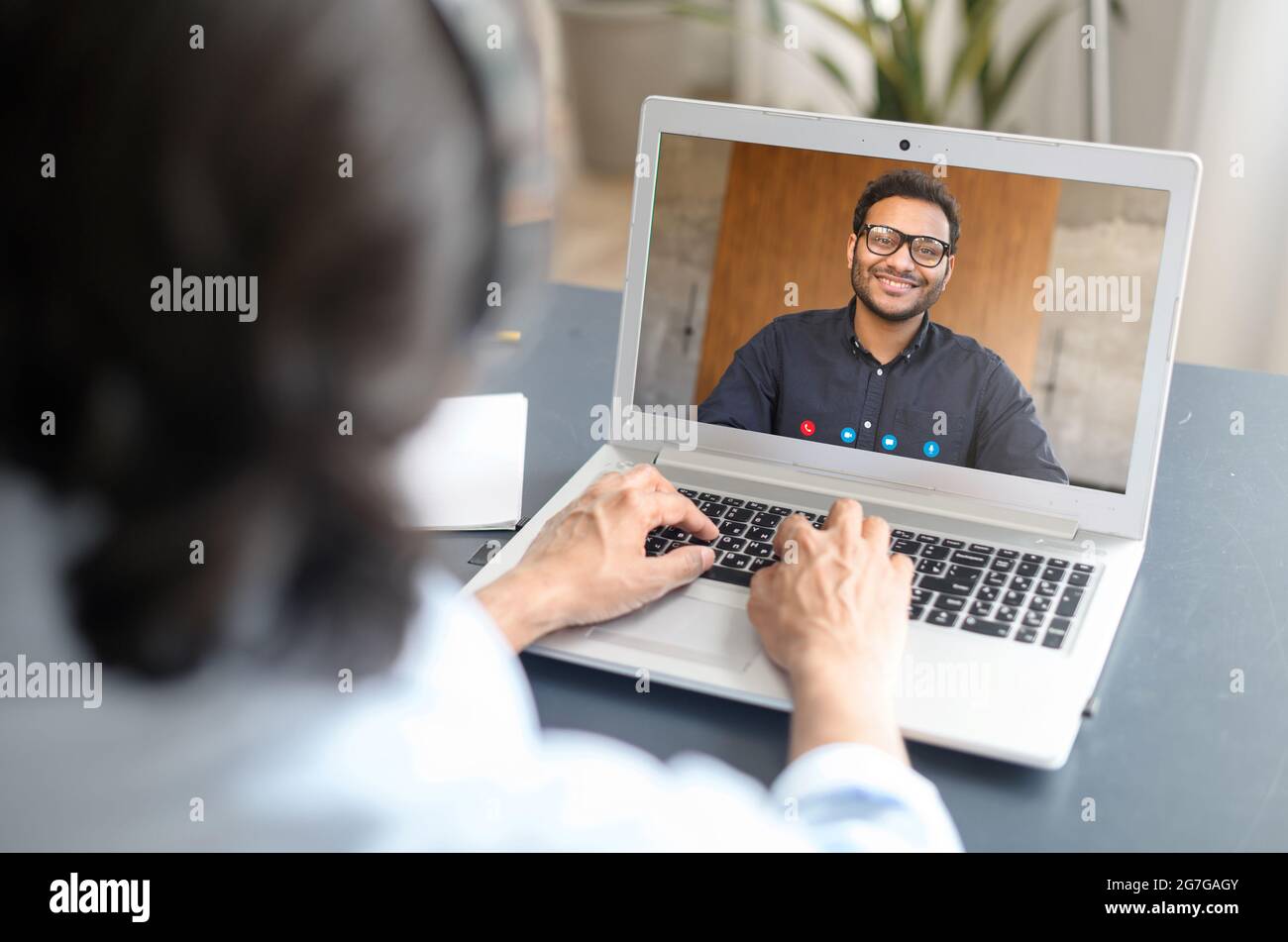 Two indian colleagues or friends speaking through the screen, using ...