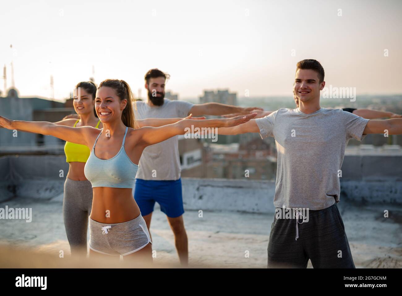 Group of happy fit people friends exercising together outdoor Stock ...