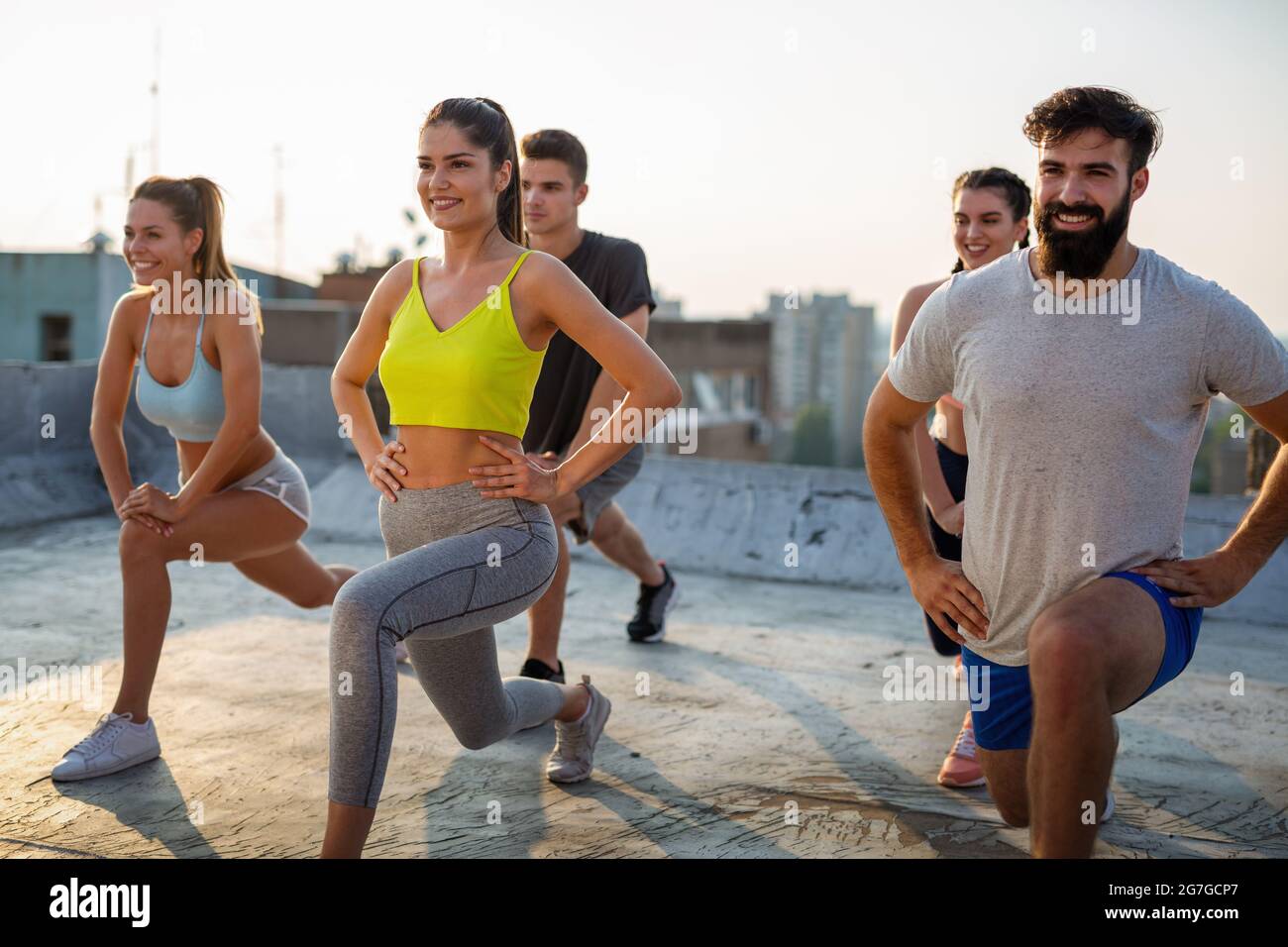 Group of fit healthy friend, people exercising together outdoor Stock ...