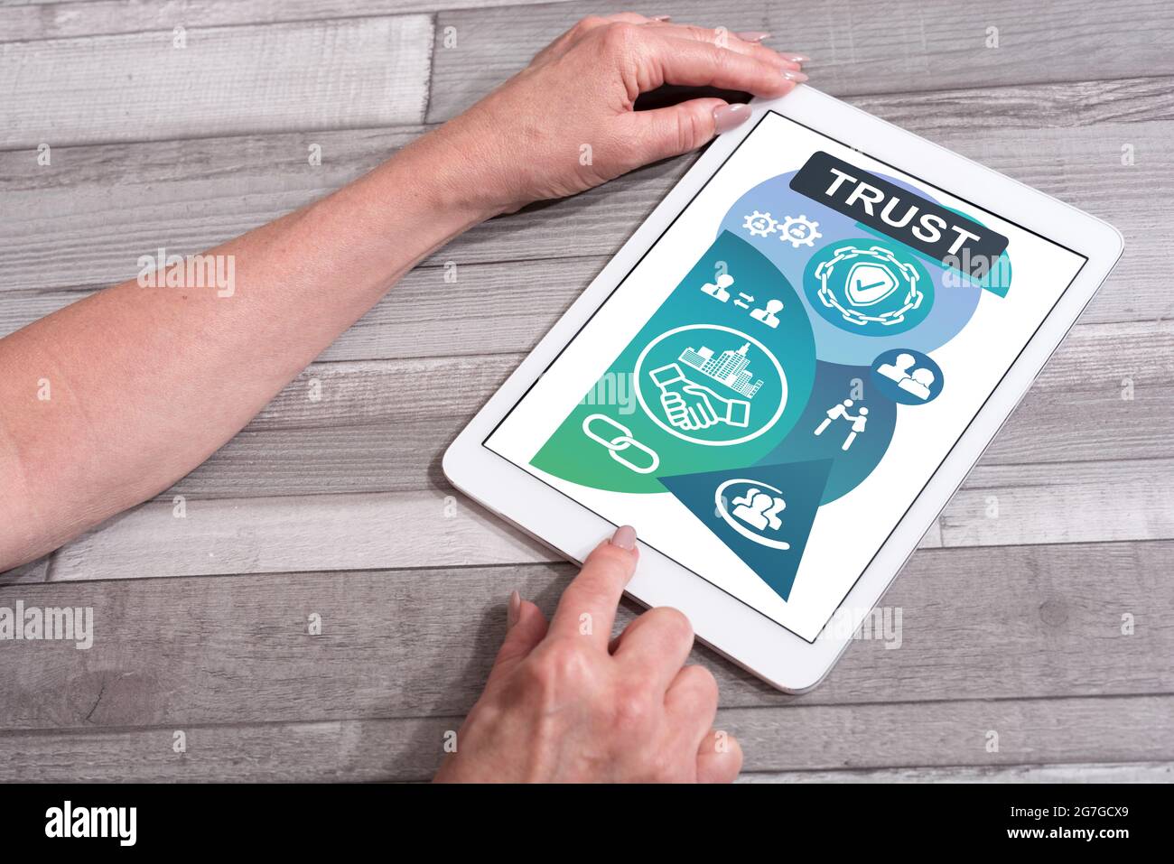 Trust concept shown on a tablet used by a woman Stock Photo - Alamy