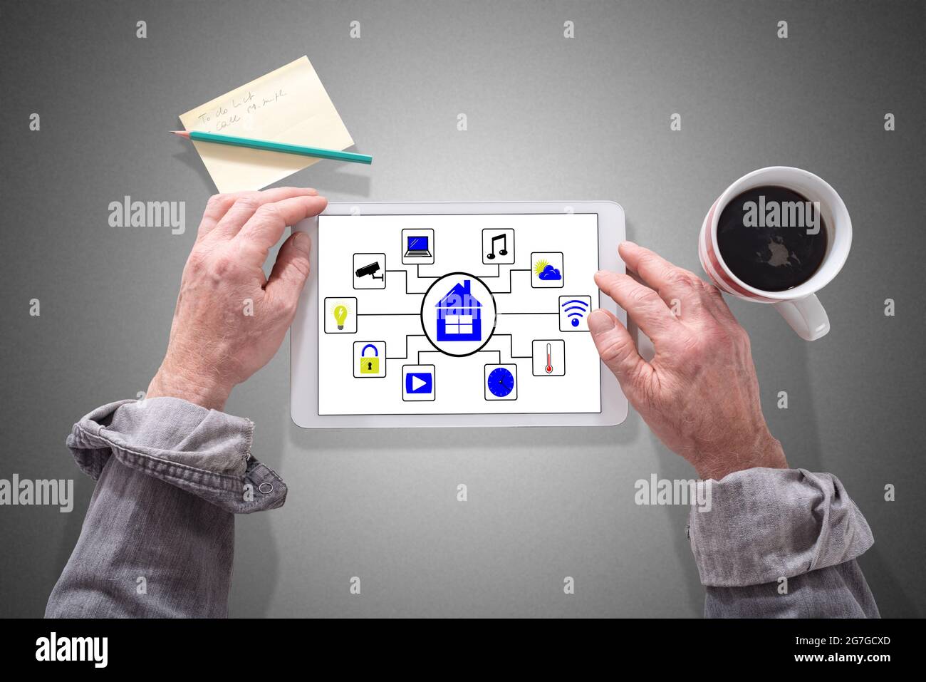 Male hands using a tablet showing smart home concept Stock Photo - Alamy