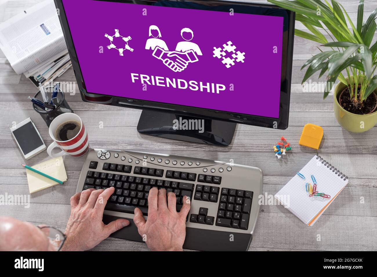 Man using a computer with friendship concept on the screen Stock Photo ...