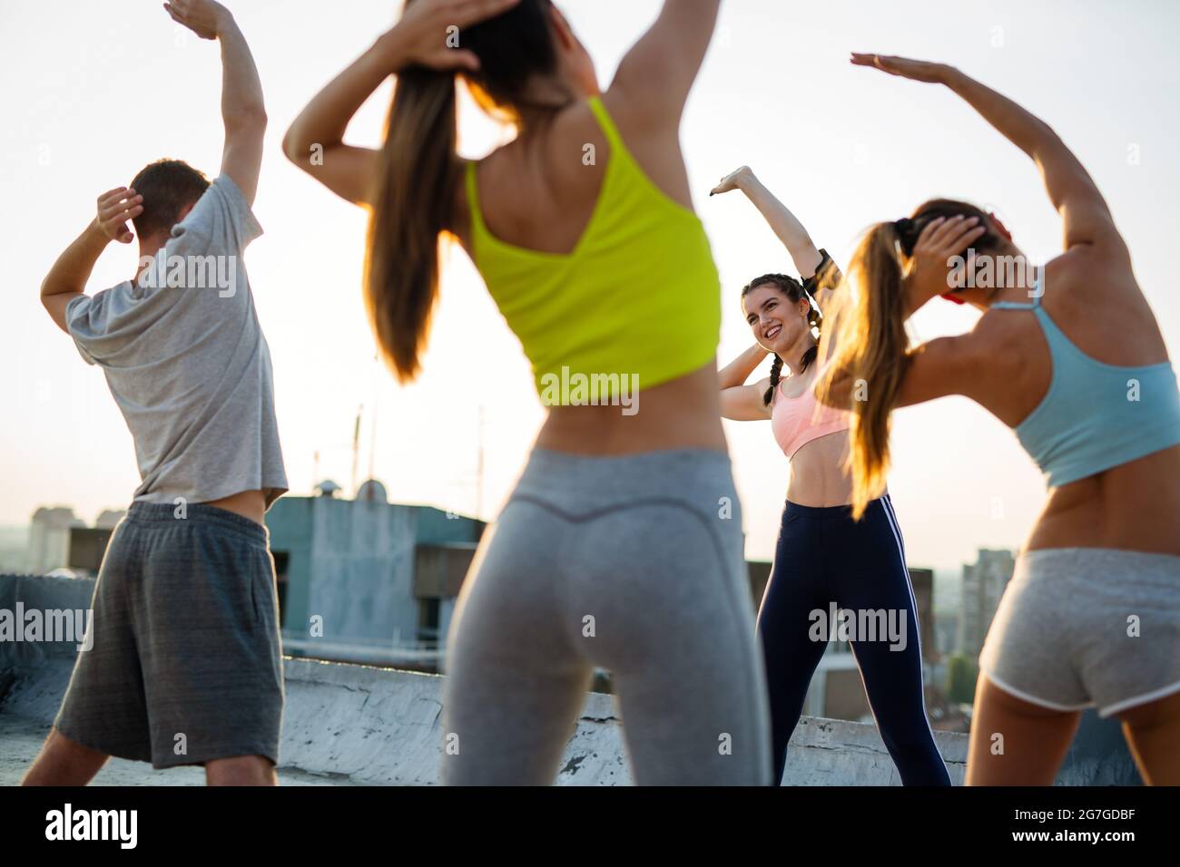 Group of happy friends working out together outdoors. Fitness, training ...