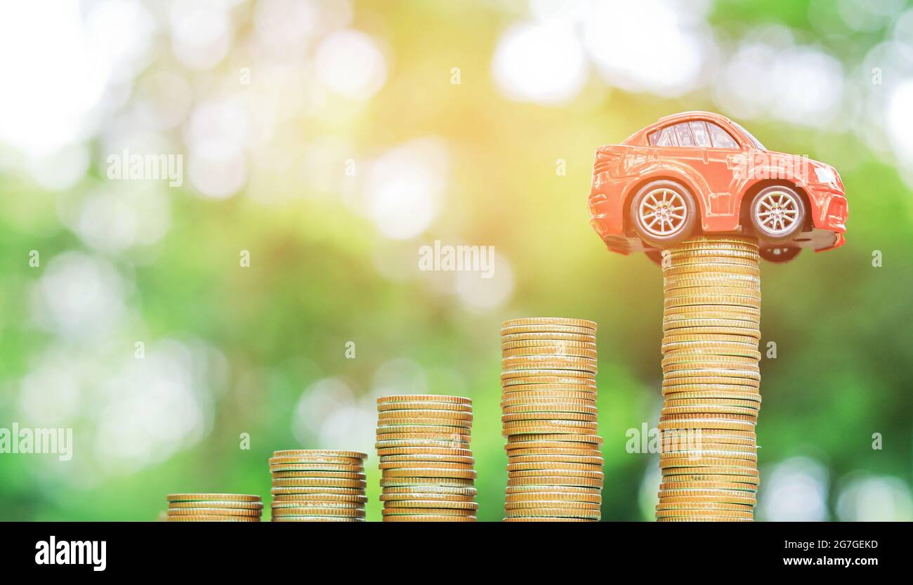 Red car on coin natural blurred background Concept of car insurance ...