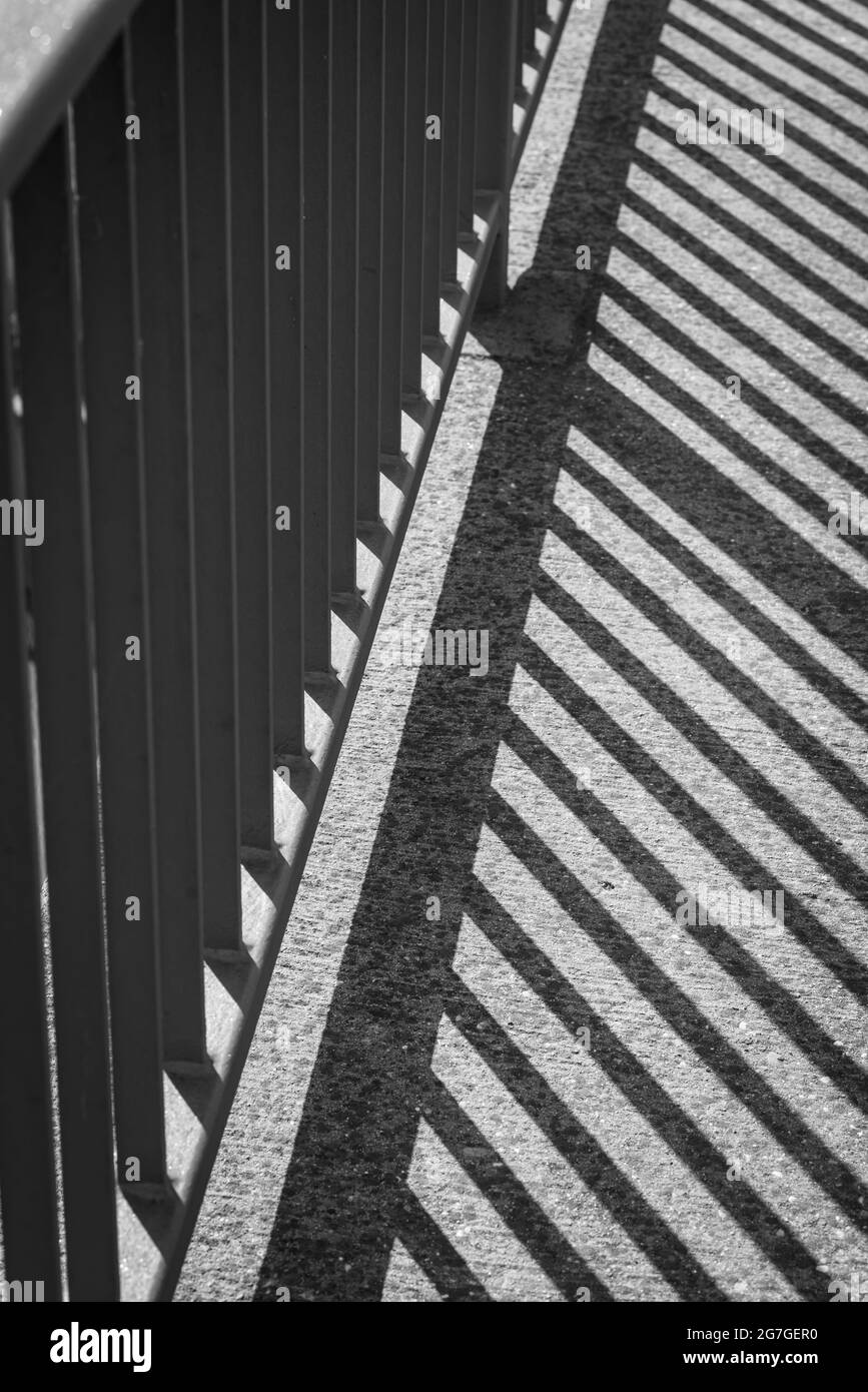 Monochrome railing with shadows Stock Photo - Alamy