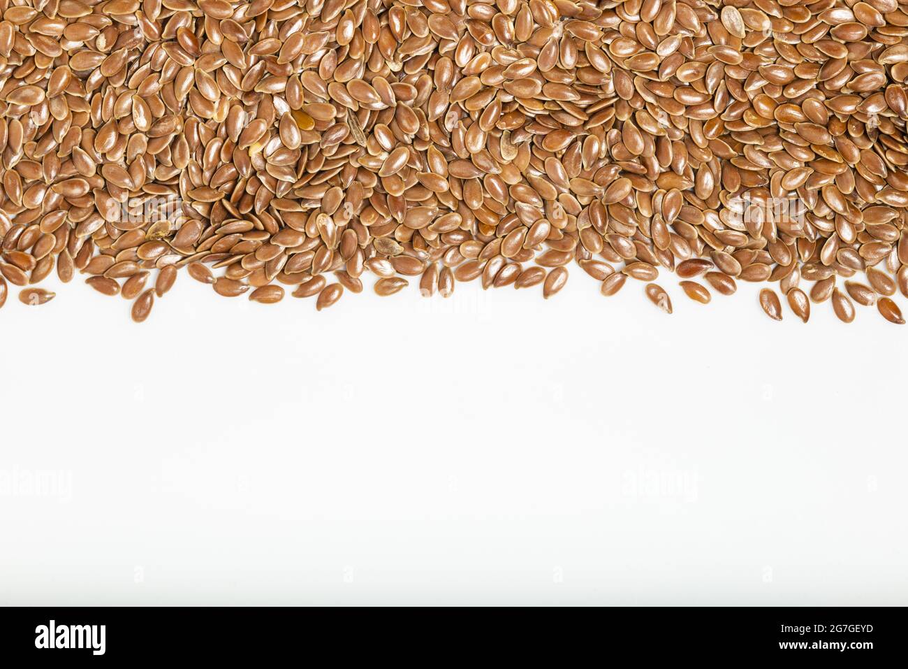 Close up of flax seeds, as background. White background. Top view ...