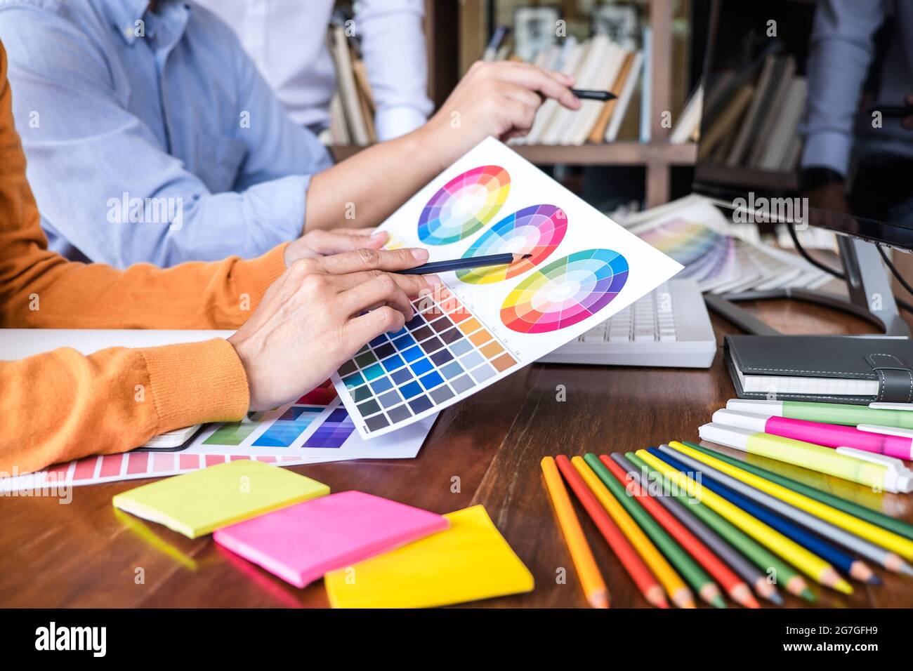 Two colleague creative graphic designer working on color selection and ...