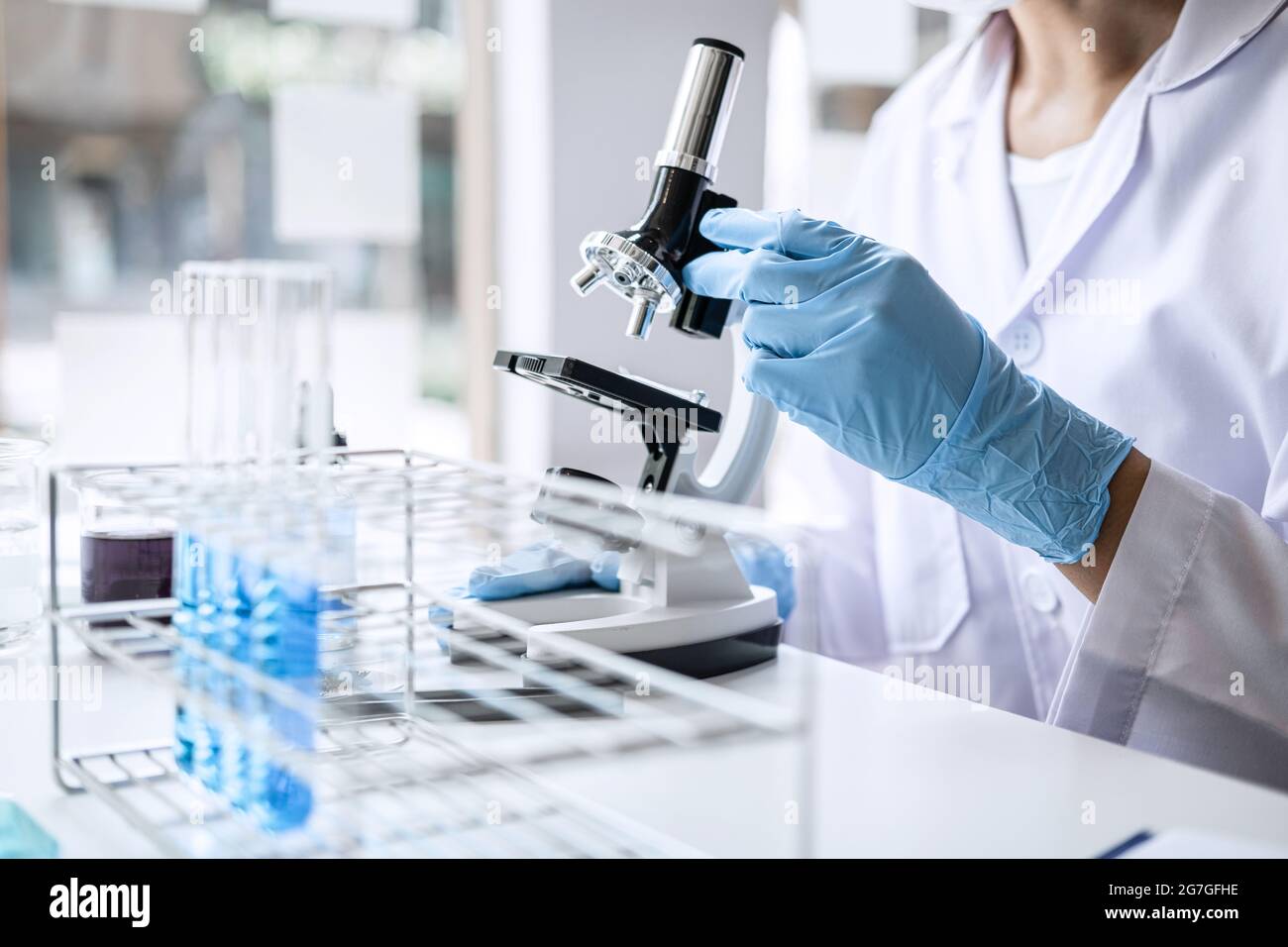 Scientist or medical in lab coat working in biotechnological laboratory ...