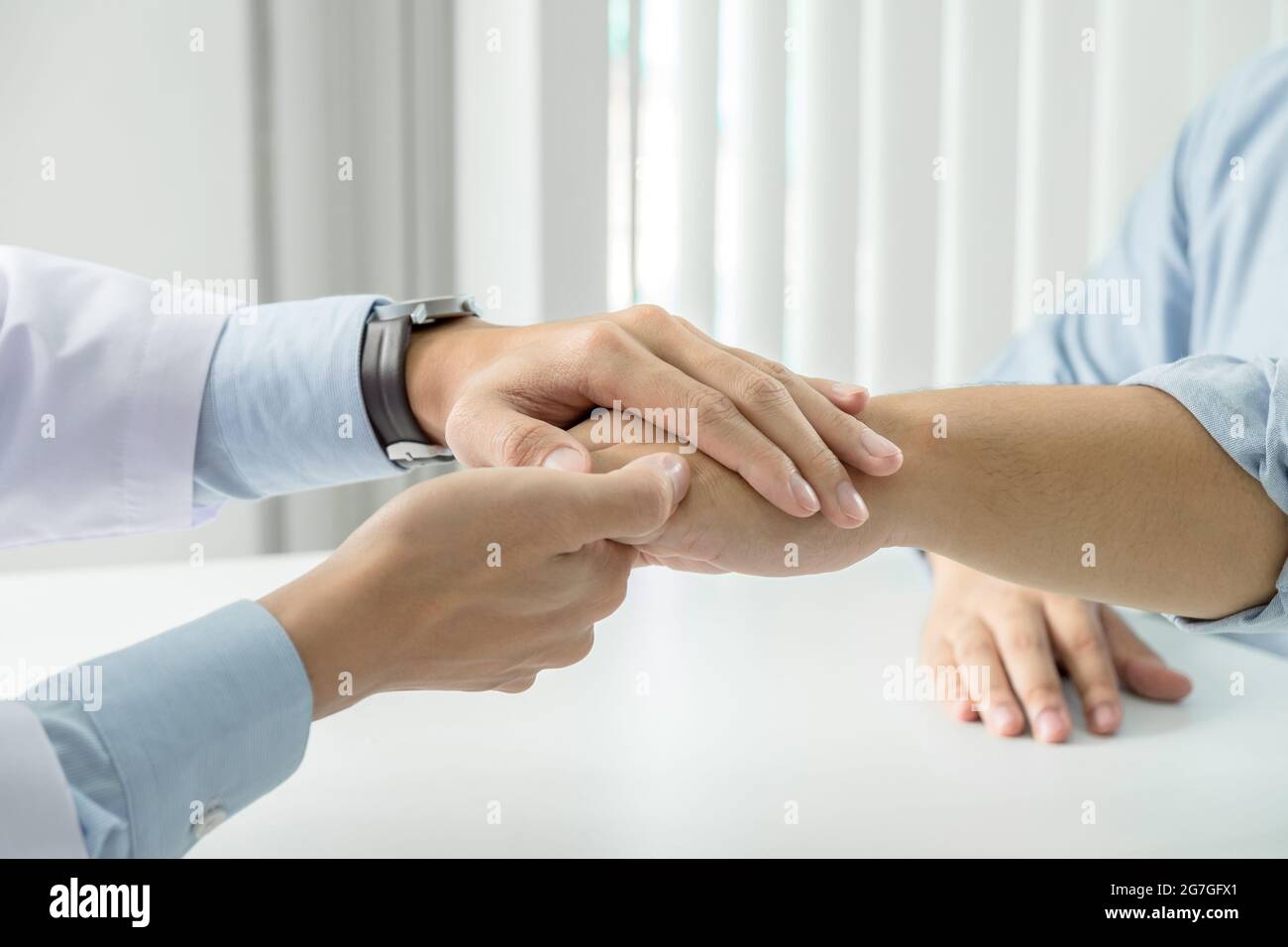 Close up of doctor touching patient hand for encouragement and empathy ...