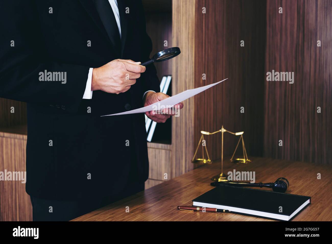 Male lawyer reading legal contract agreement and examining documents ...