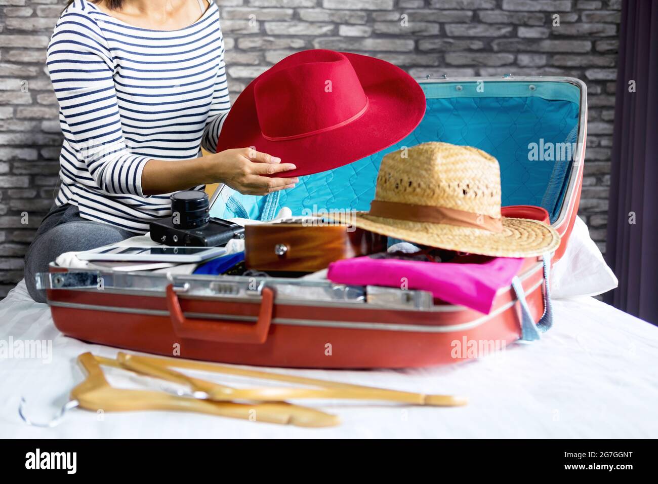 Travel and vacation concept, happiness young woman packing a lot of her ...