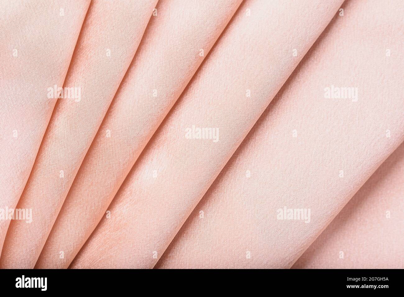 Elegant coral silk fabric background with waves. Close up abstract ...