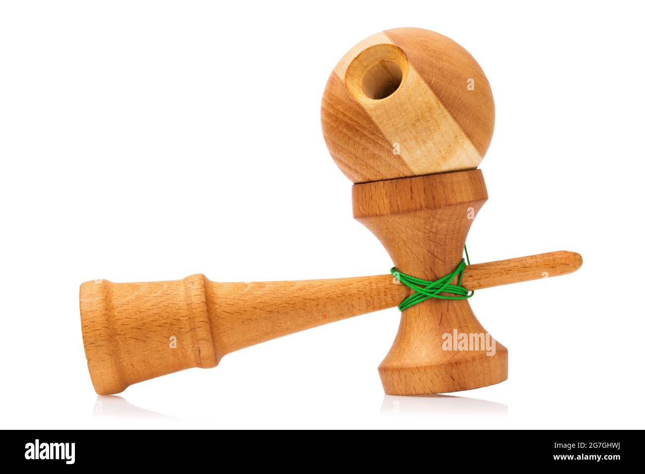 Childrens wooden kendama toy with green threads isolated on white ...