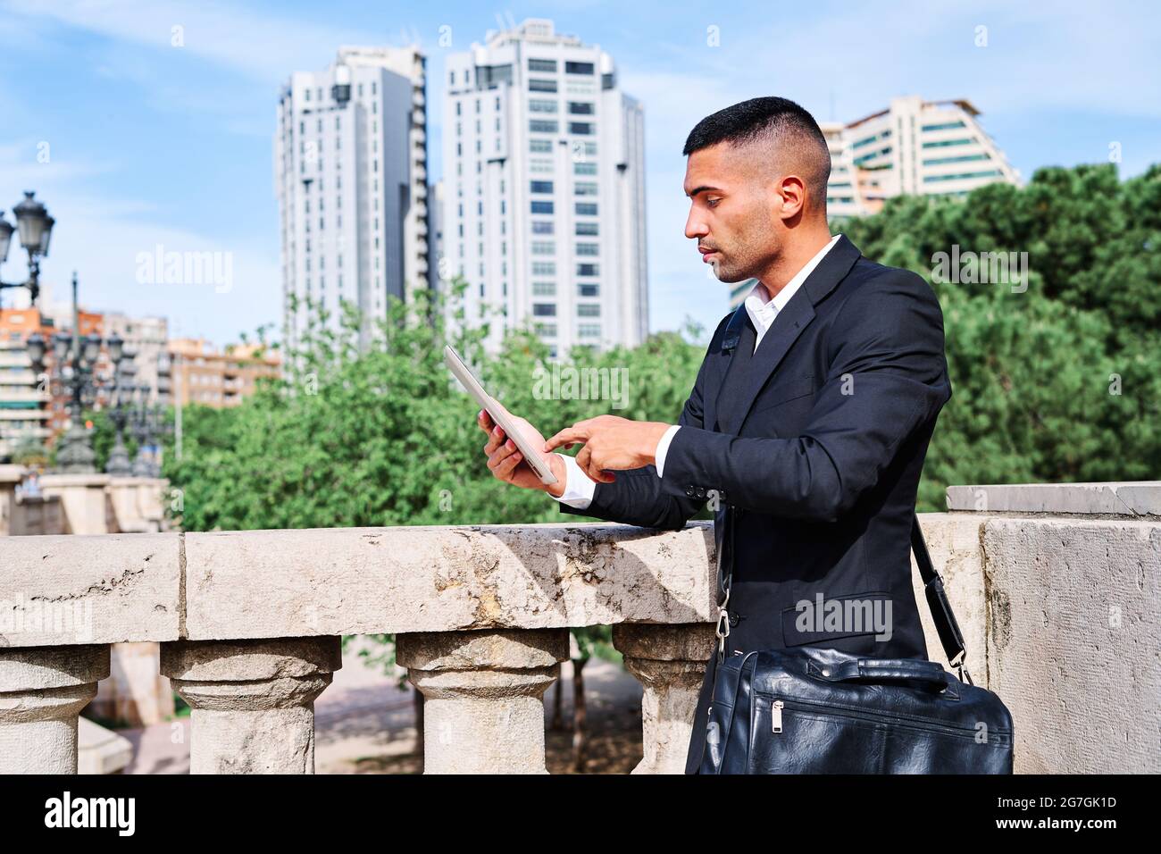 Side view of focused young Hispanic male executive manager in classy ...
