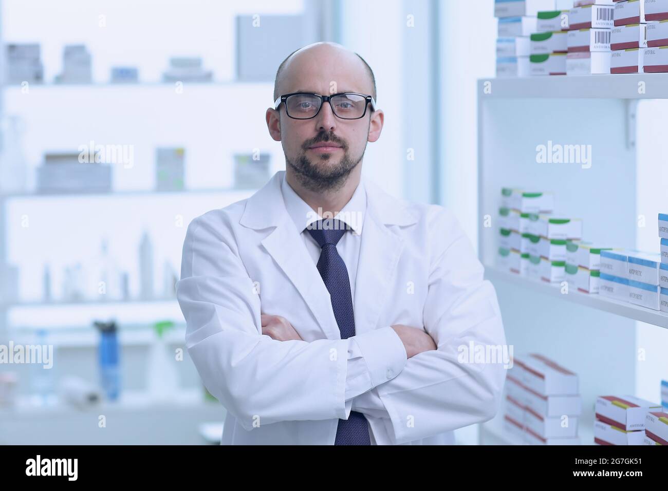 Pharmacist is working. Man wearing special uniform located in pharmacy ...