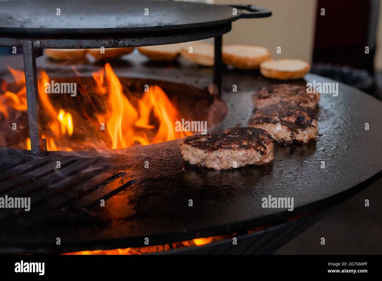 Process of grilling cutlets for burgers on brazier with hot flame Stock ...