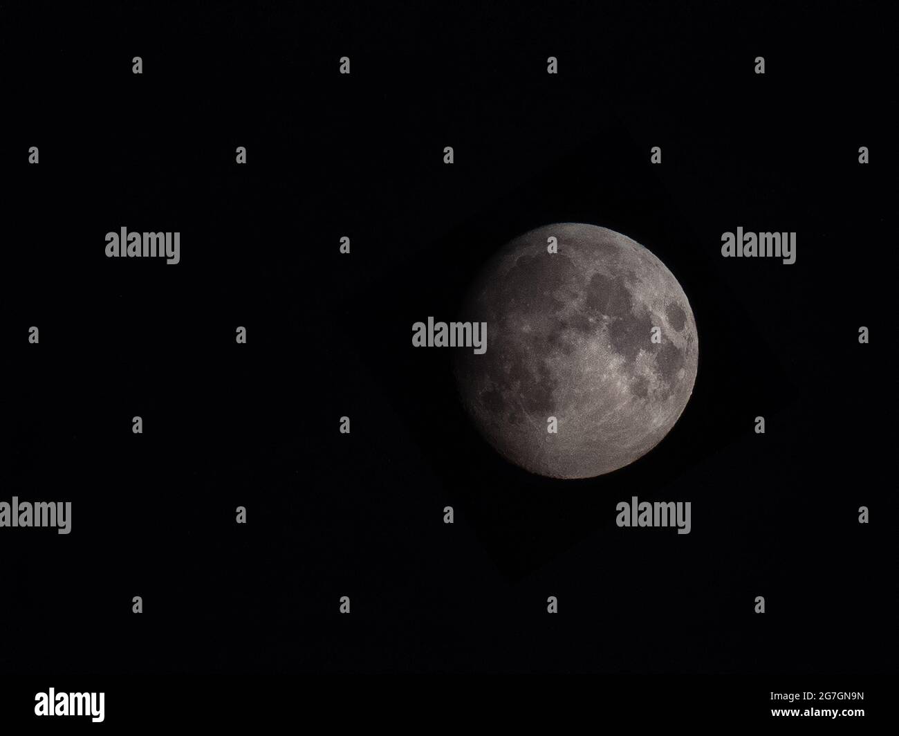 Almost full moon in the night sky Stock Photo - Alamy