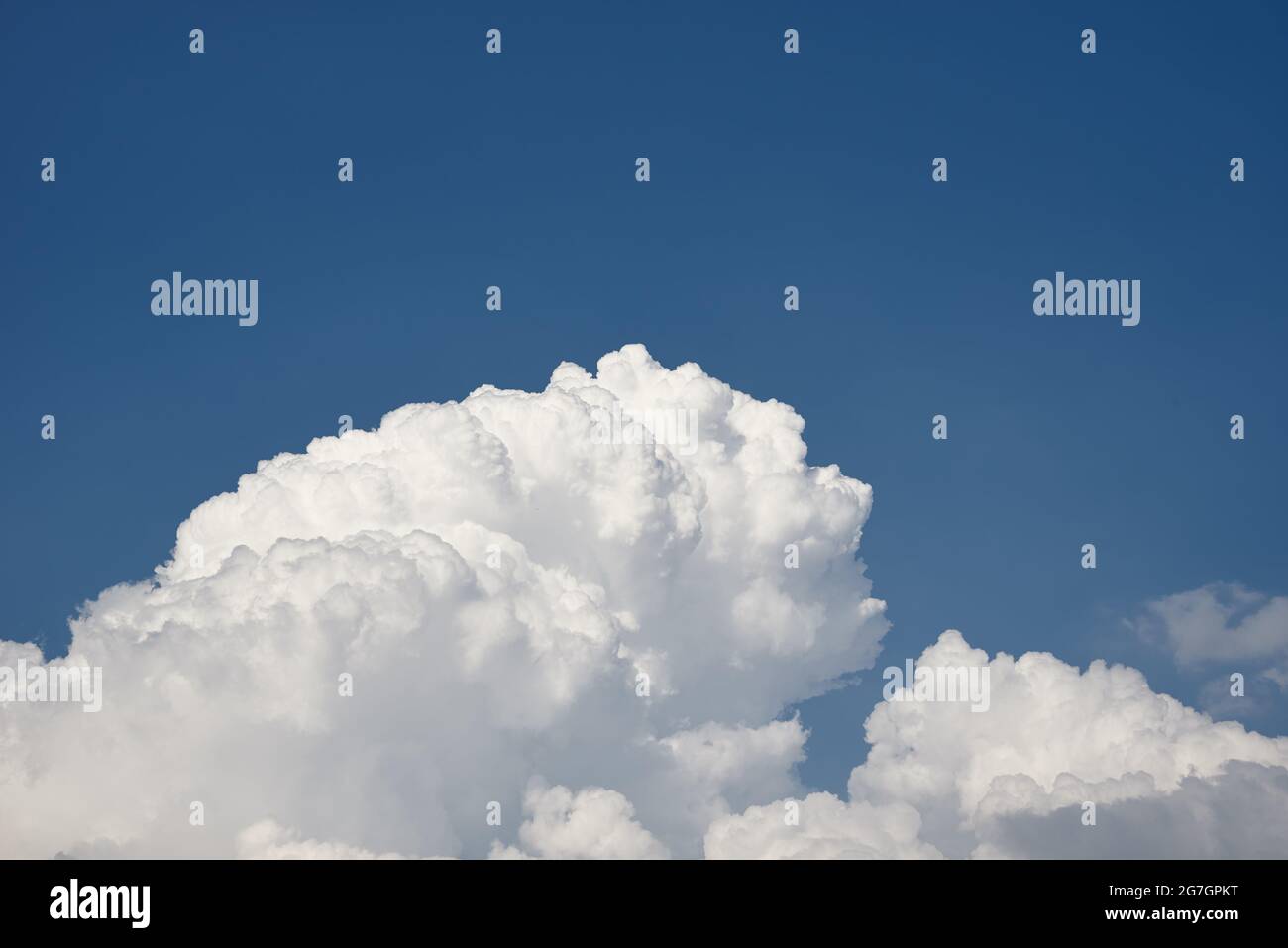 Big white fluffy clouds on clear blue sky. Cloudy sky background with ...