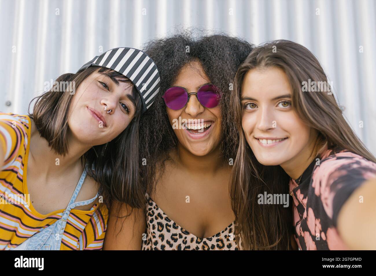 Three beautiful young women of different races with their long board ...