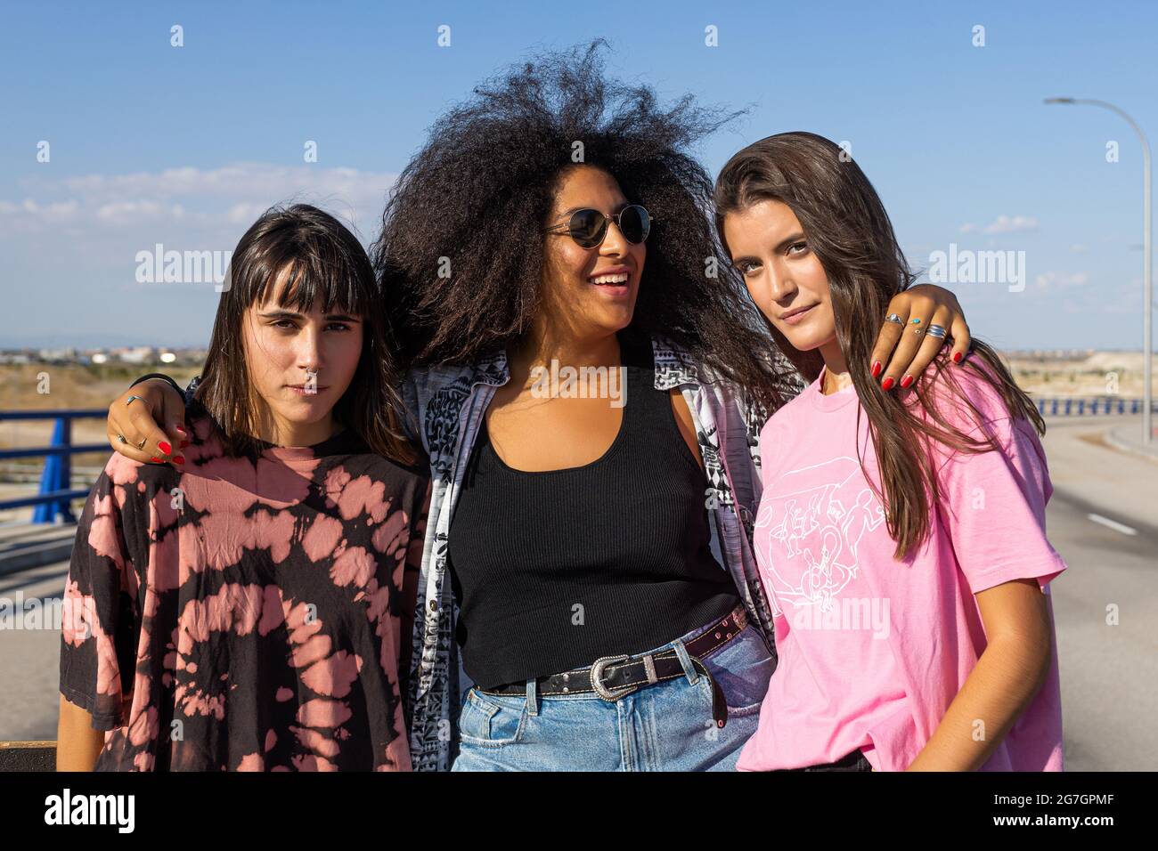 Three beautiful young women of different races with their long board ...