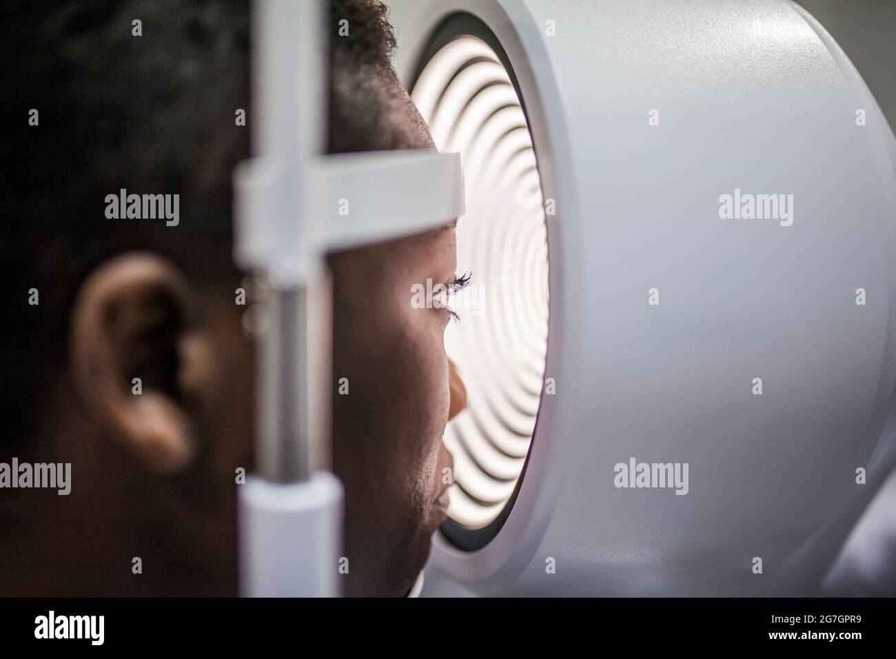 Black Woman in optometry cabinet during study of the eyesight using a ...