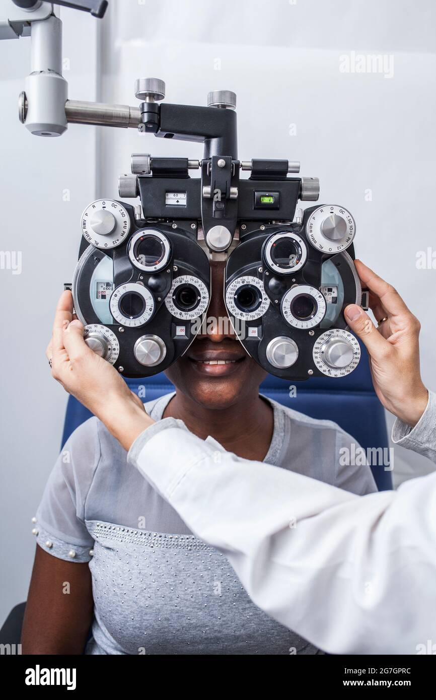 Optometrist adjusting the optometry equipment during study of the ...