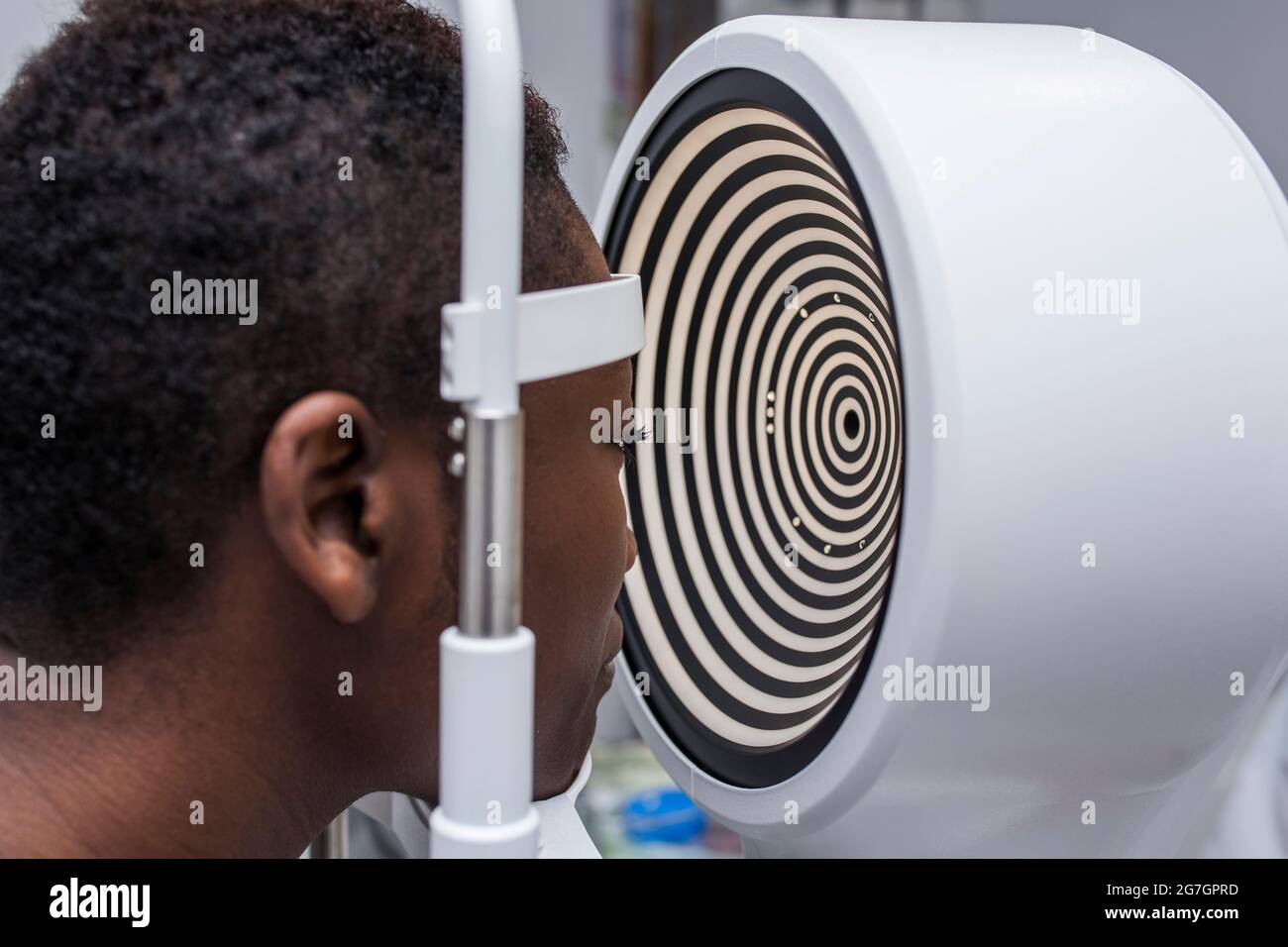 Black Woman in optometry cabinet during study of the eyesight using a ...