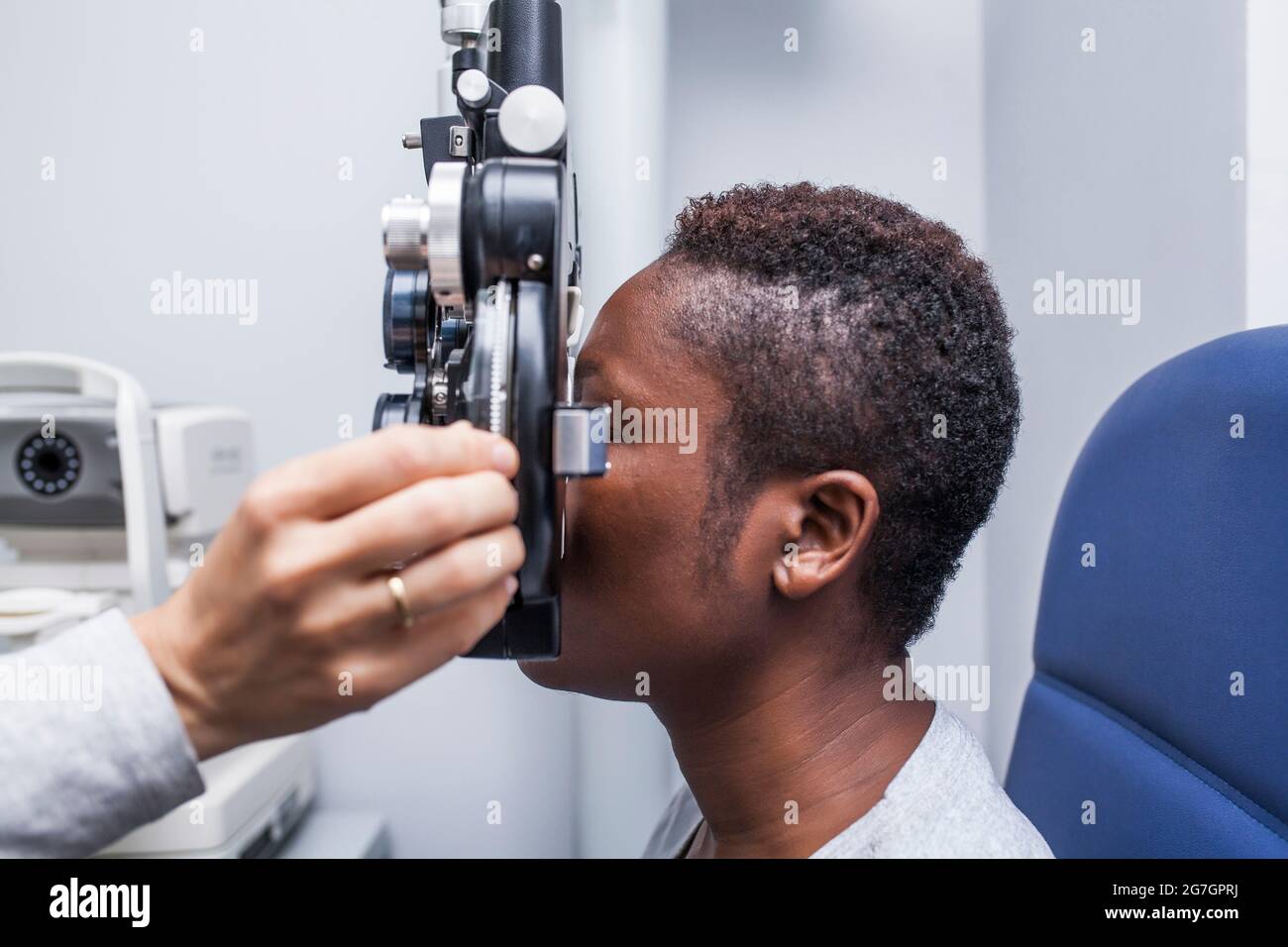 Optometrist adjusting the optometry equipment during study of the ...