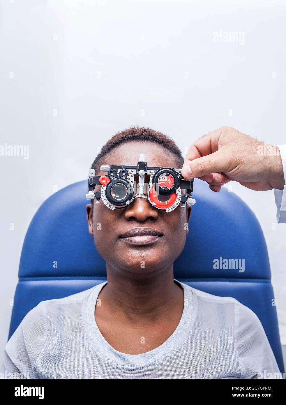Optometrist adjusting the optometry equipment during study of the ...