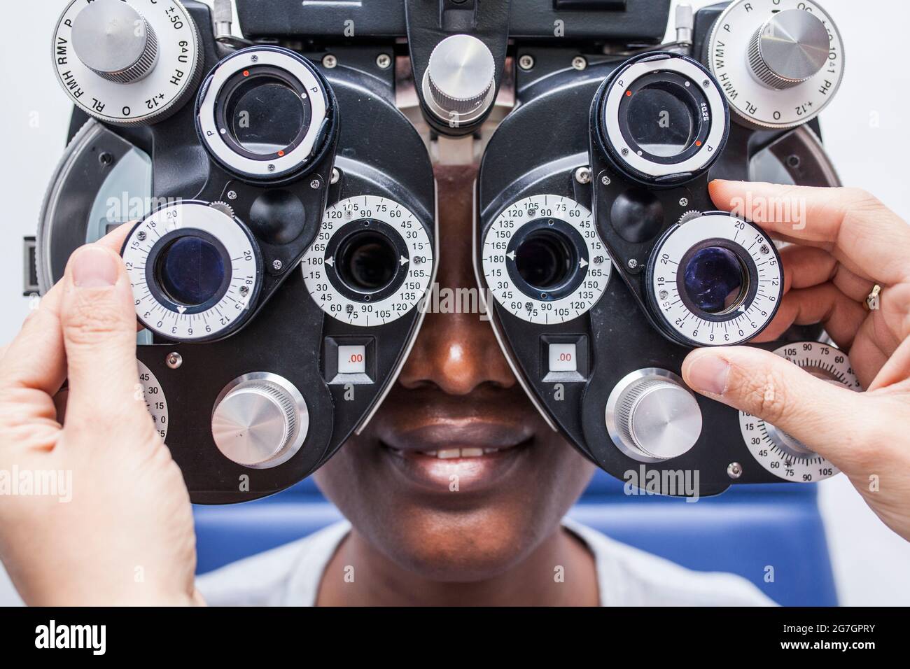 Optometrist adjusting the optometry equipment during study of the ...