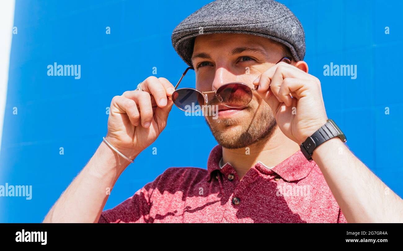 Young professional female mime in casual clothes painting the eyebrows ...