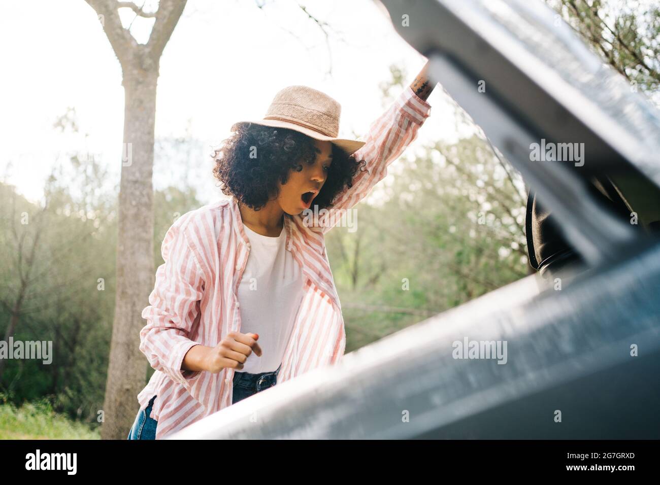 Side view of unhappy young African American female driver getting ...