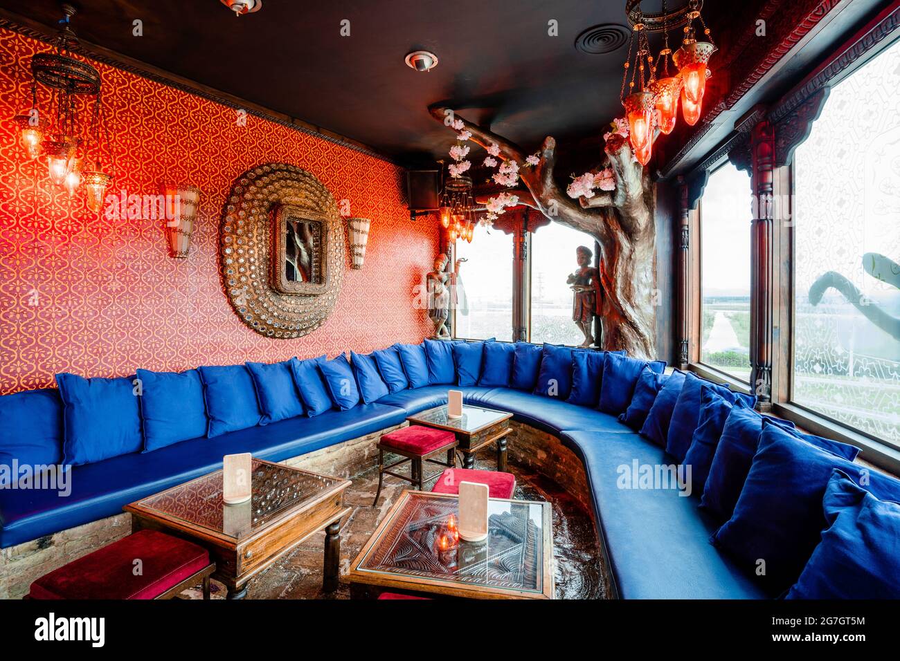 Cozy interior of cocktail bar with comfortable sofa with cushions and ...