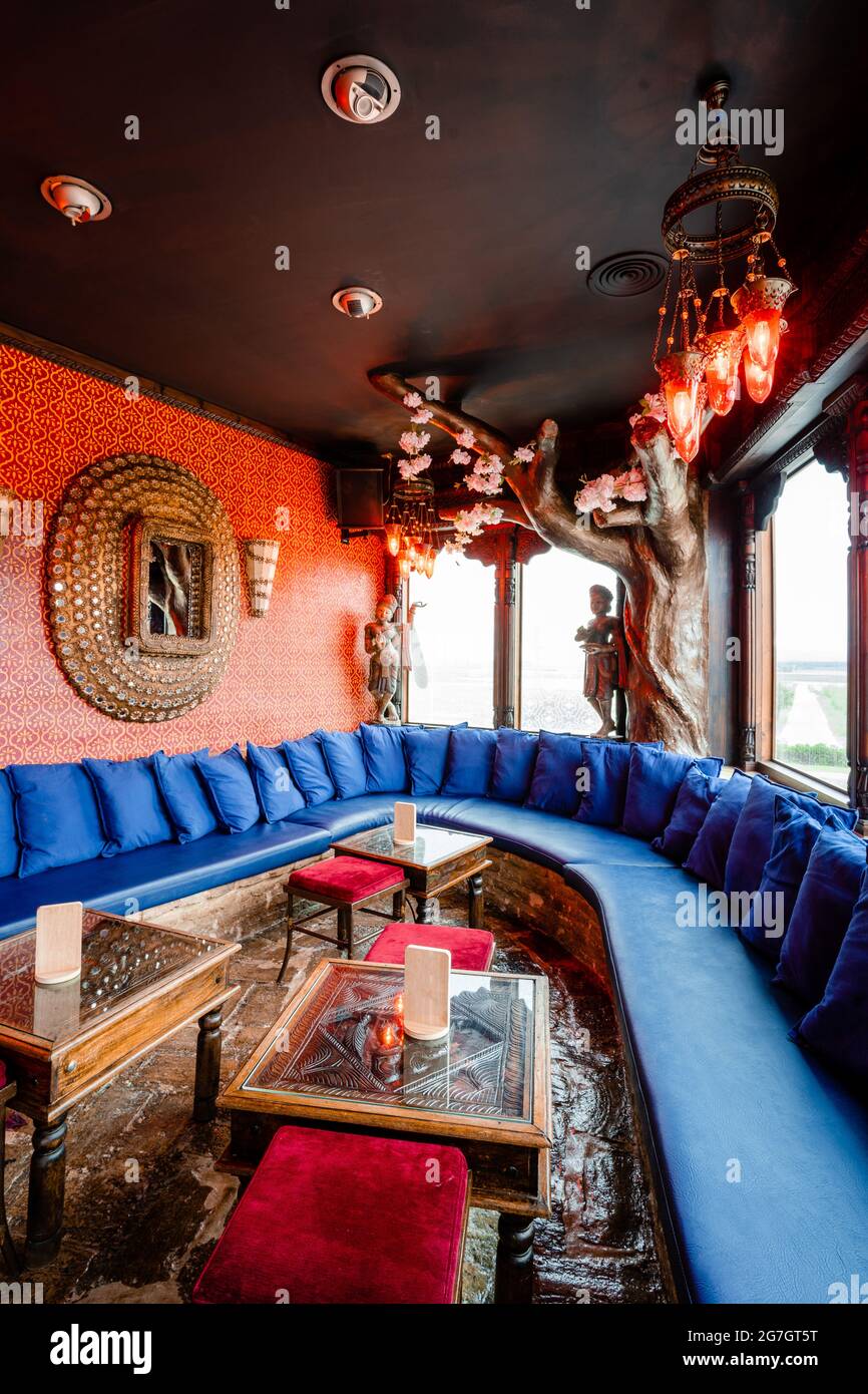 Cozy interior of cocktail bar with comfortable sofa with cushions and ...