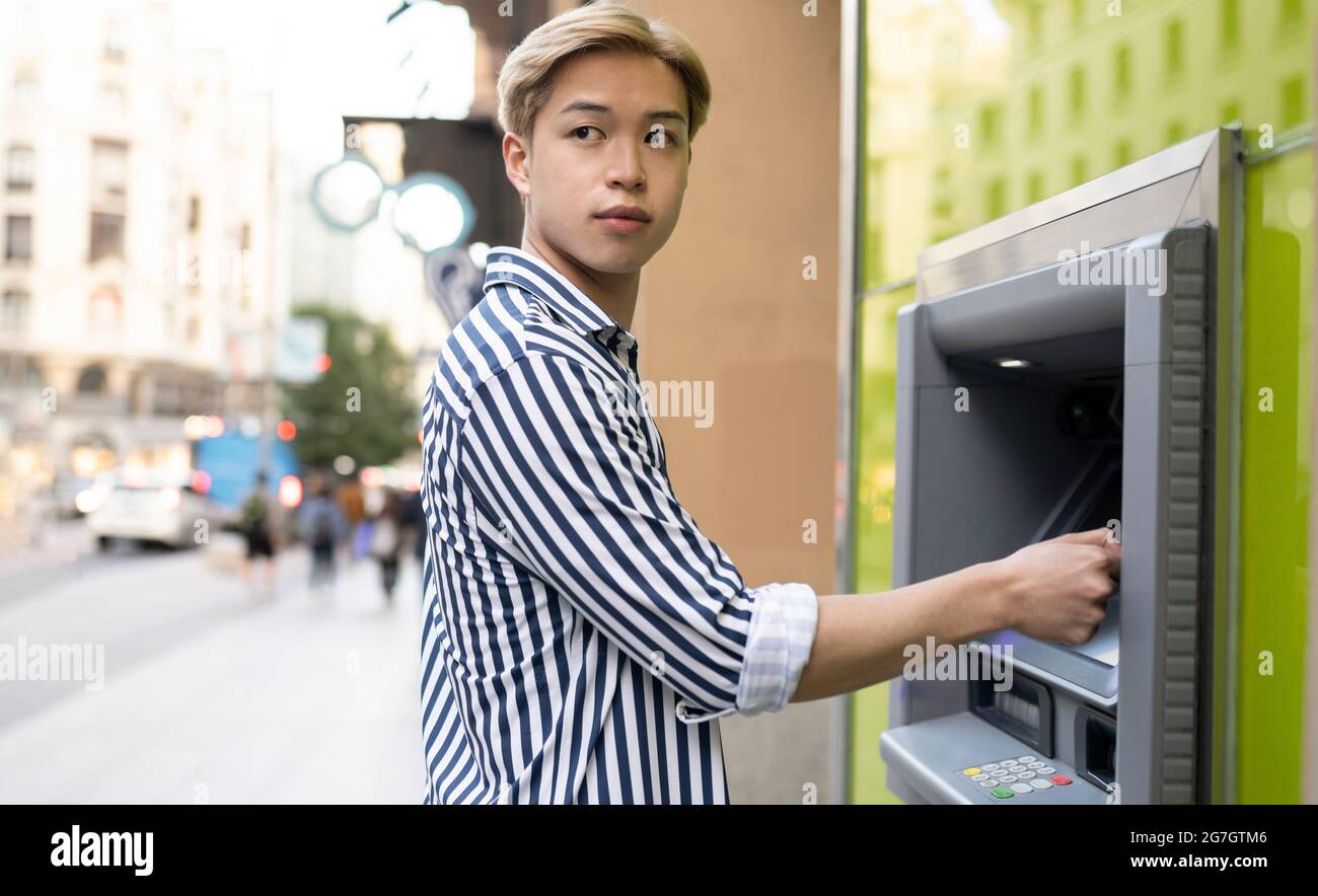 Male withdrawing cash at atm hi-res stock photography and images - Alamy