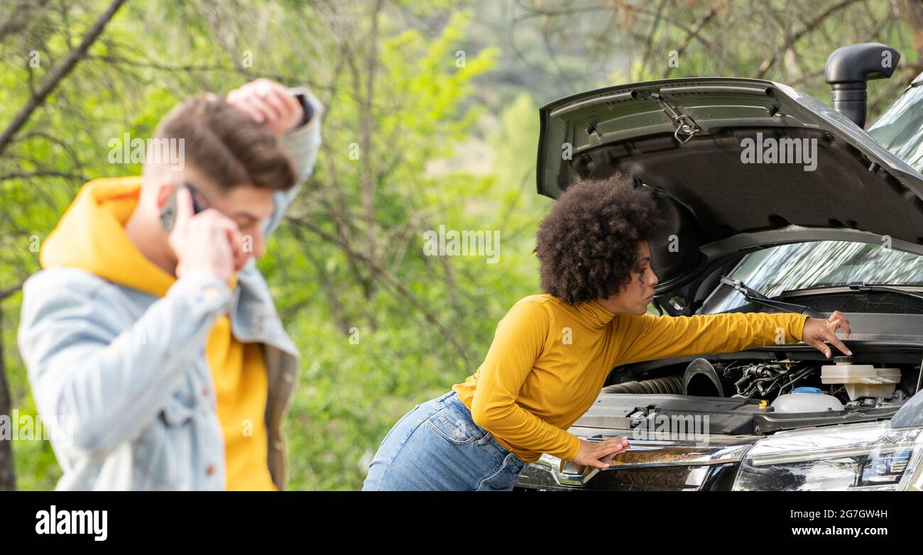 African American female opening coolant container and repairing broken ...