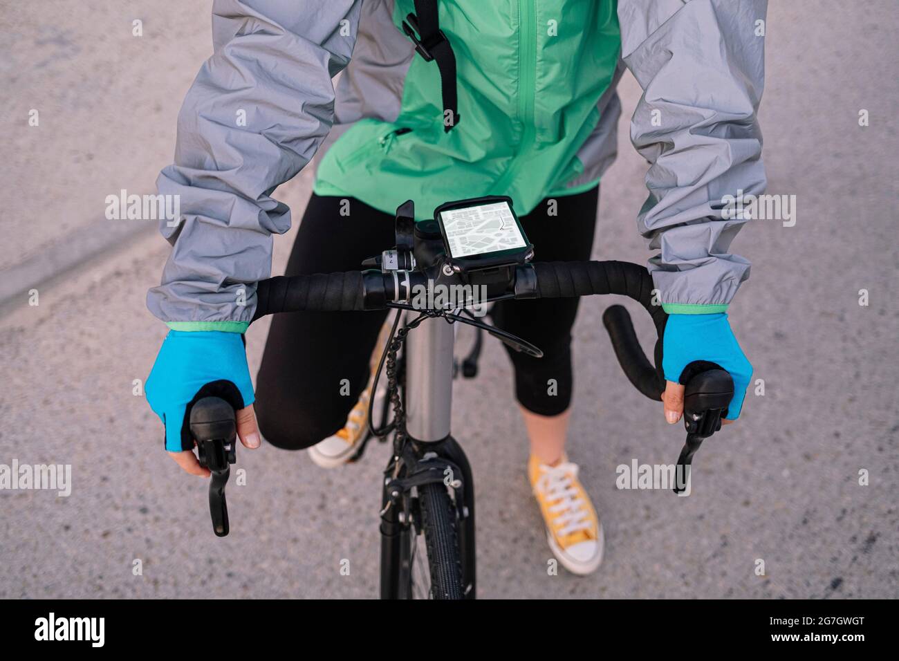 From above anonymous courier examining route on GPS map before riding ...