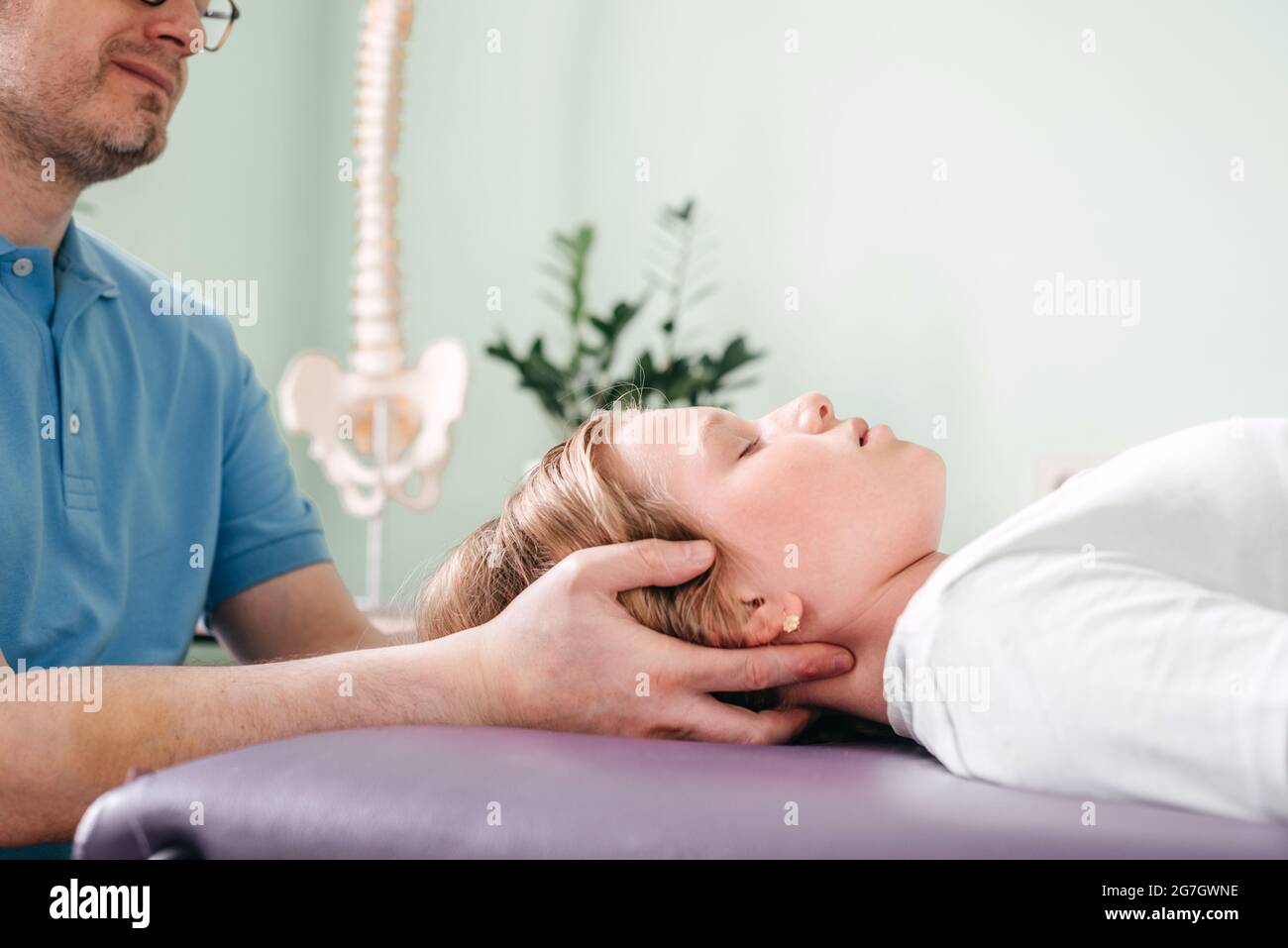 CST practitioner using light touch to provide craniosacral treatment to ...