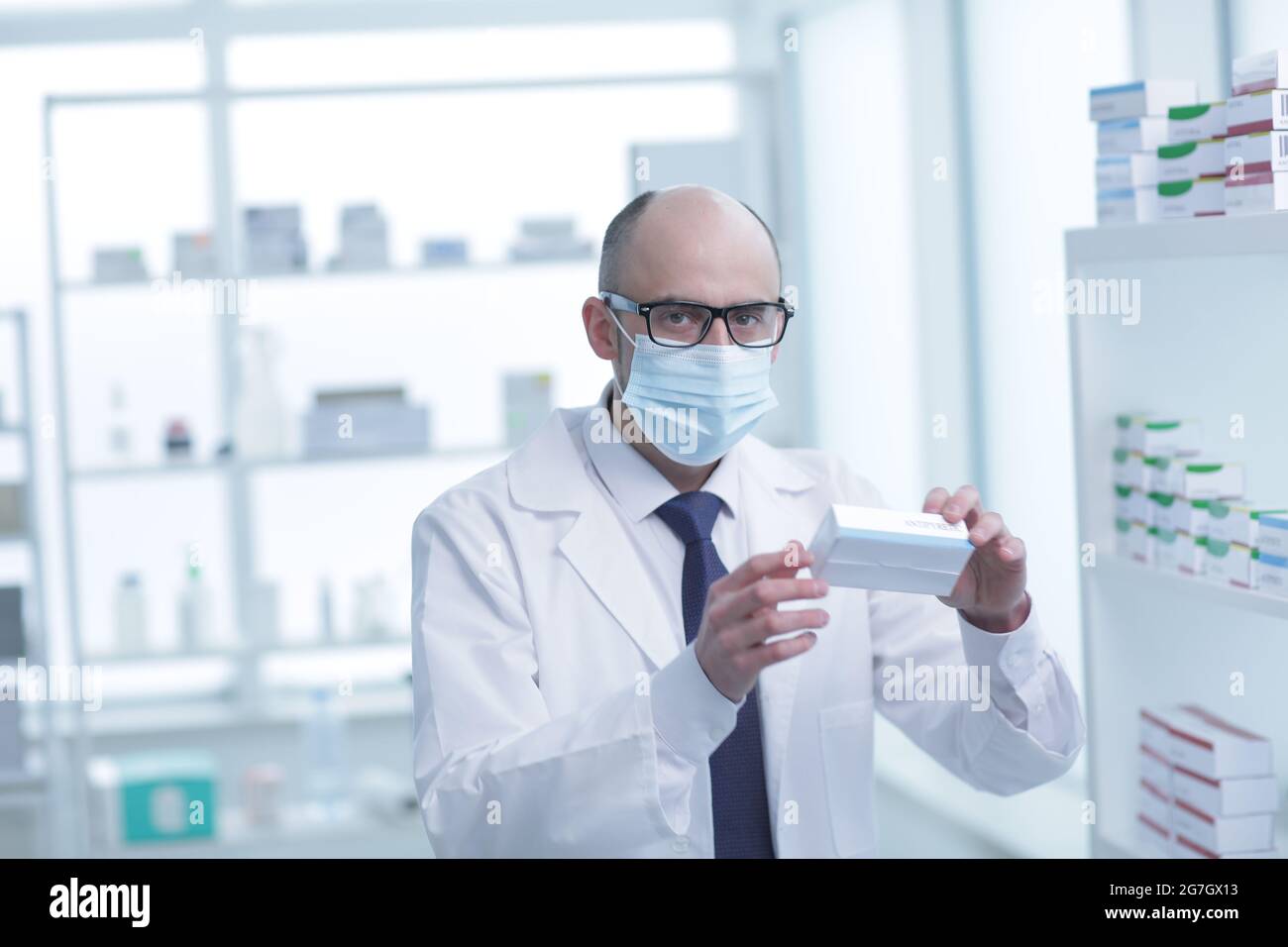 Pharmacist is Working. Man Wearing Medical Uniform. Located in Pharmacy ...
