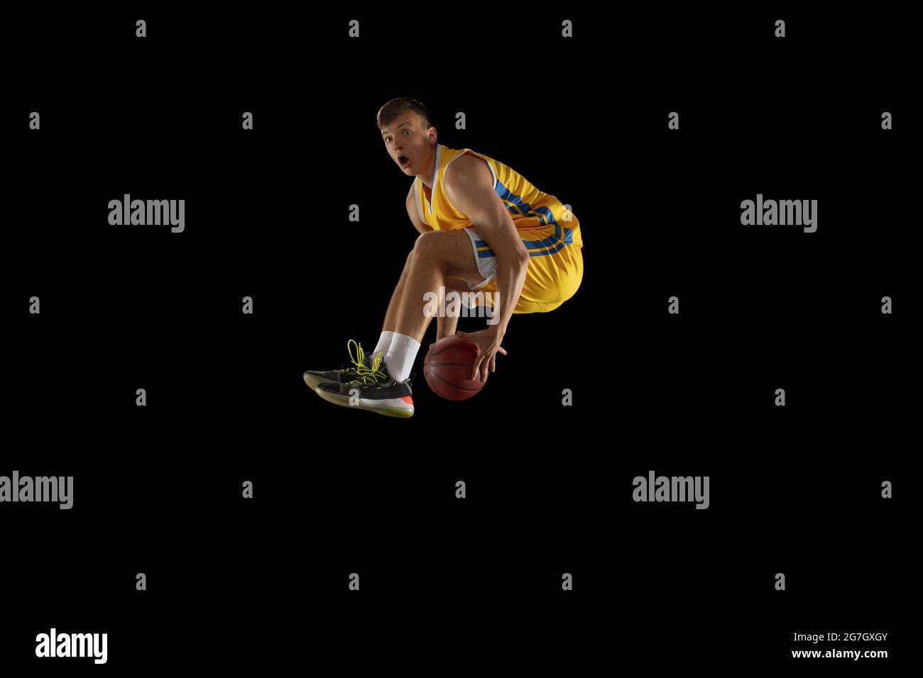 High jump. Basketball player with a ball in action and motion isolated ...